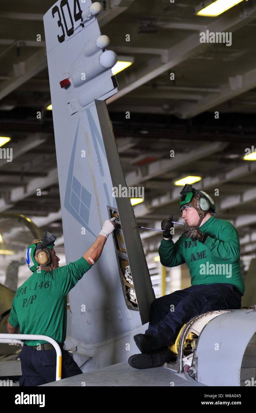 Airman German Alulzo (left) strips sealant out of a rudder as Airman ...