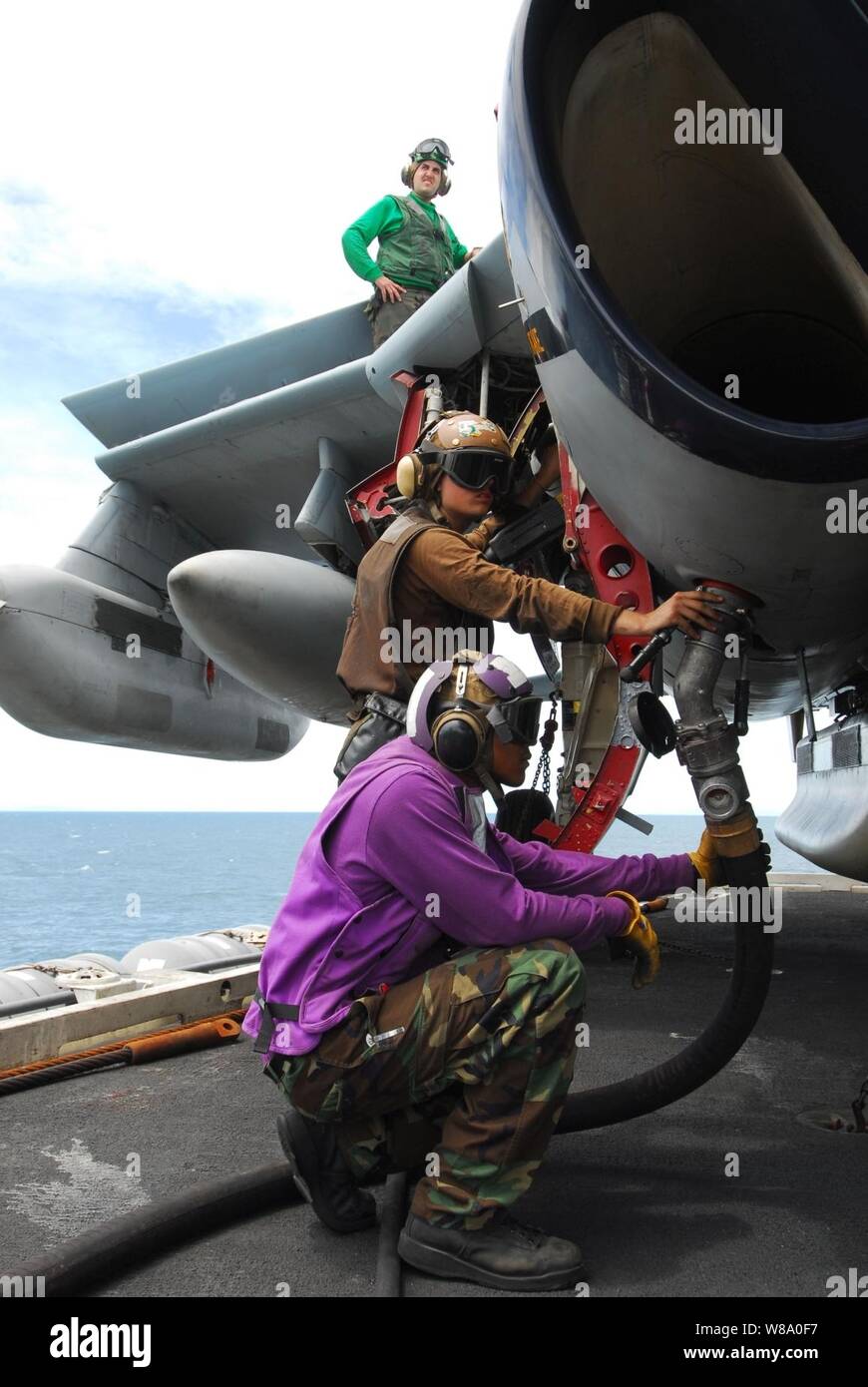 Airman Raymond Burrell and Airman Thomas Robertson fuel an EA-6B ...