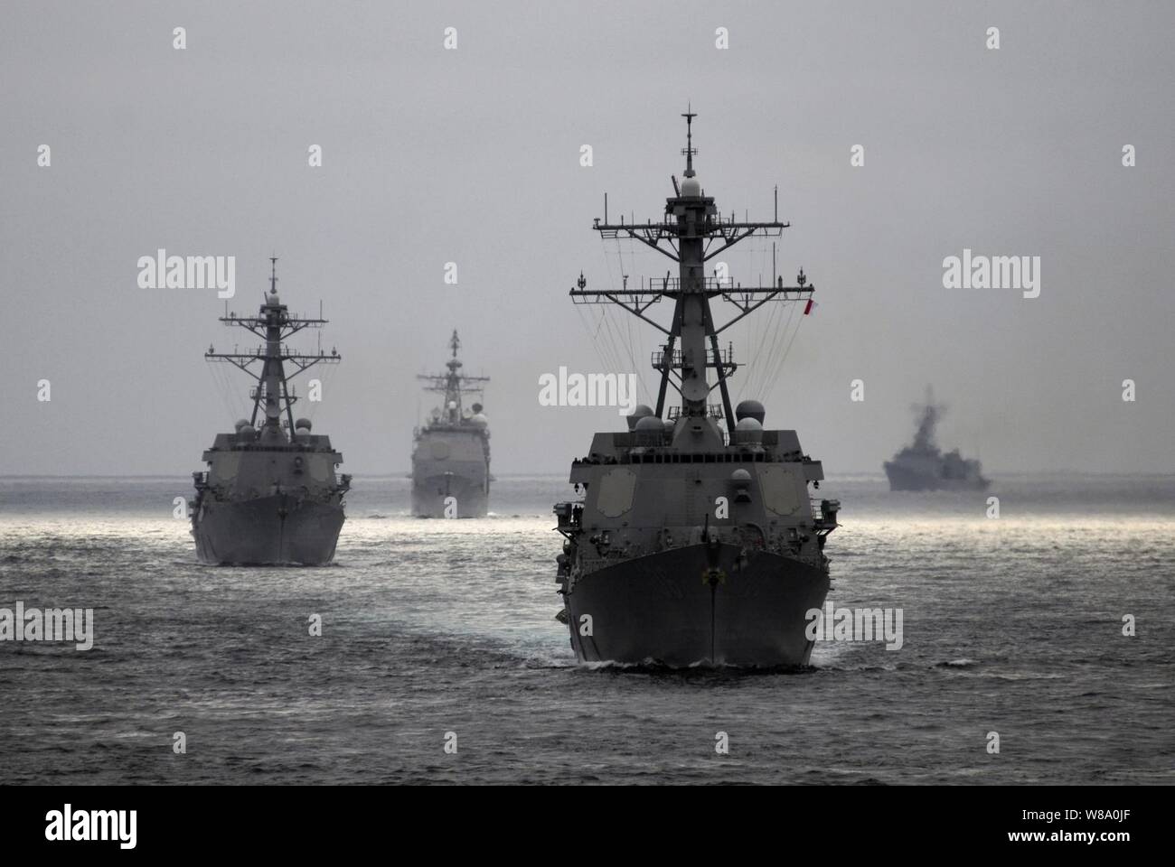 he guided missile destroyer USS Stockdale (DDG 106) leads a formation ...