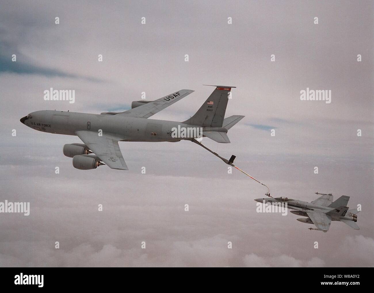 A U.S. Air Force KC-135 tanker refuels a U.S. Navy F/A-18C from Strike ...