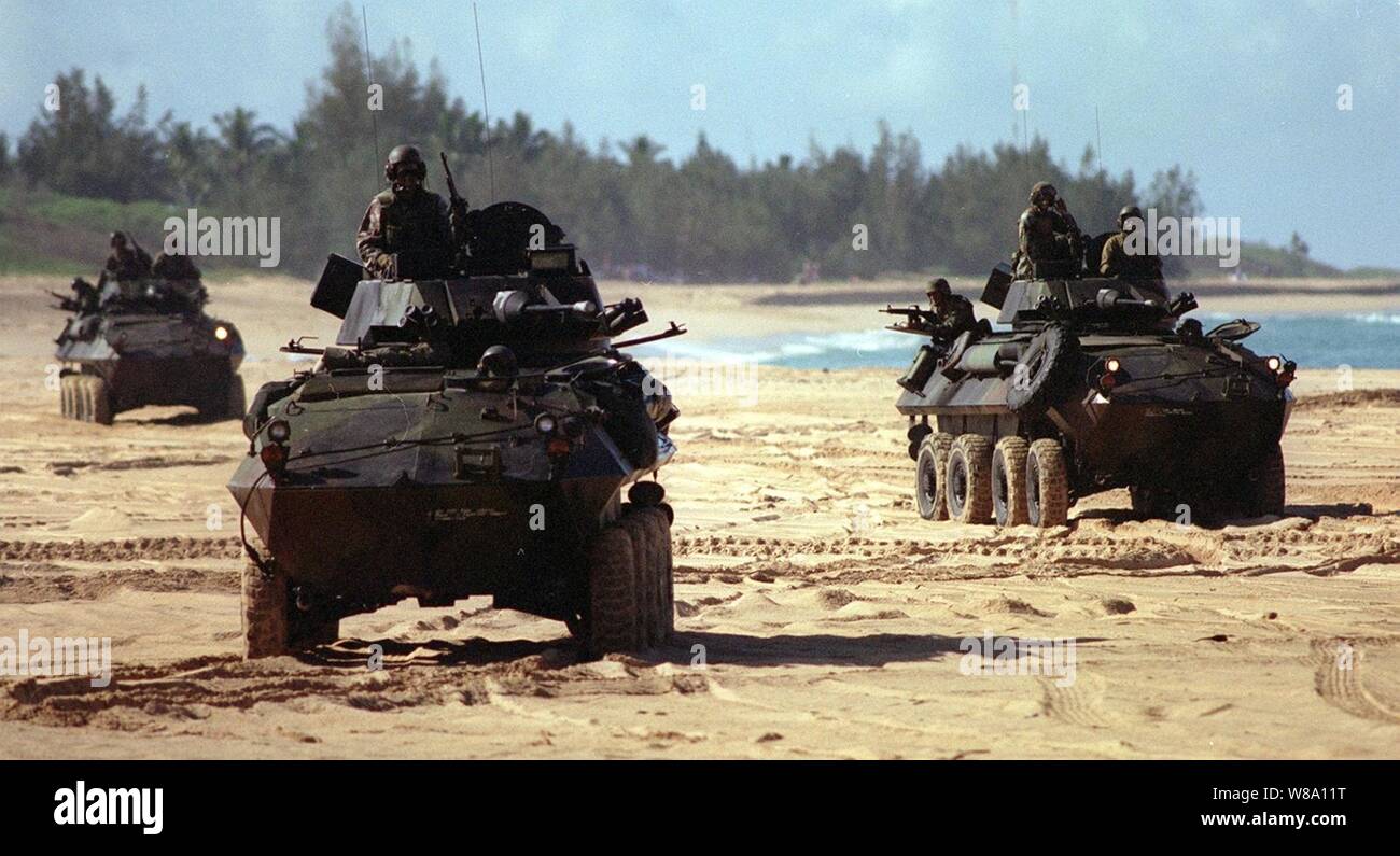 U.S. Marine Corps Light Armored Vehicles maneuver on the beach during ...