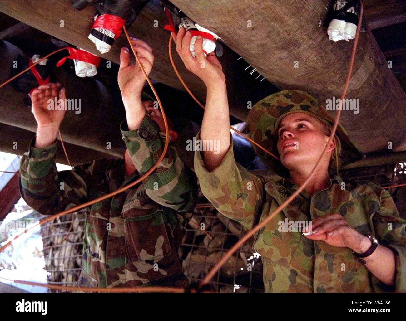 Lance Cpl. Timothy Exley (left) and Sapper Tania Dawson (right) check ...
