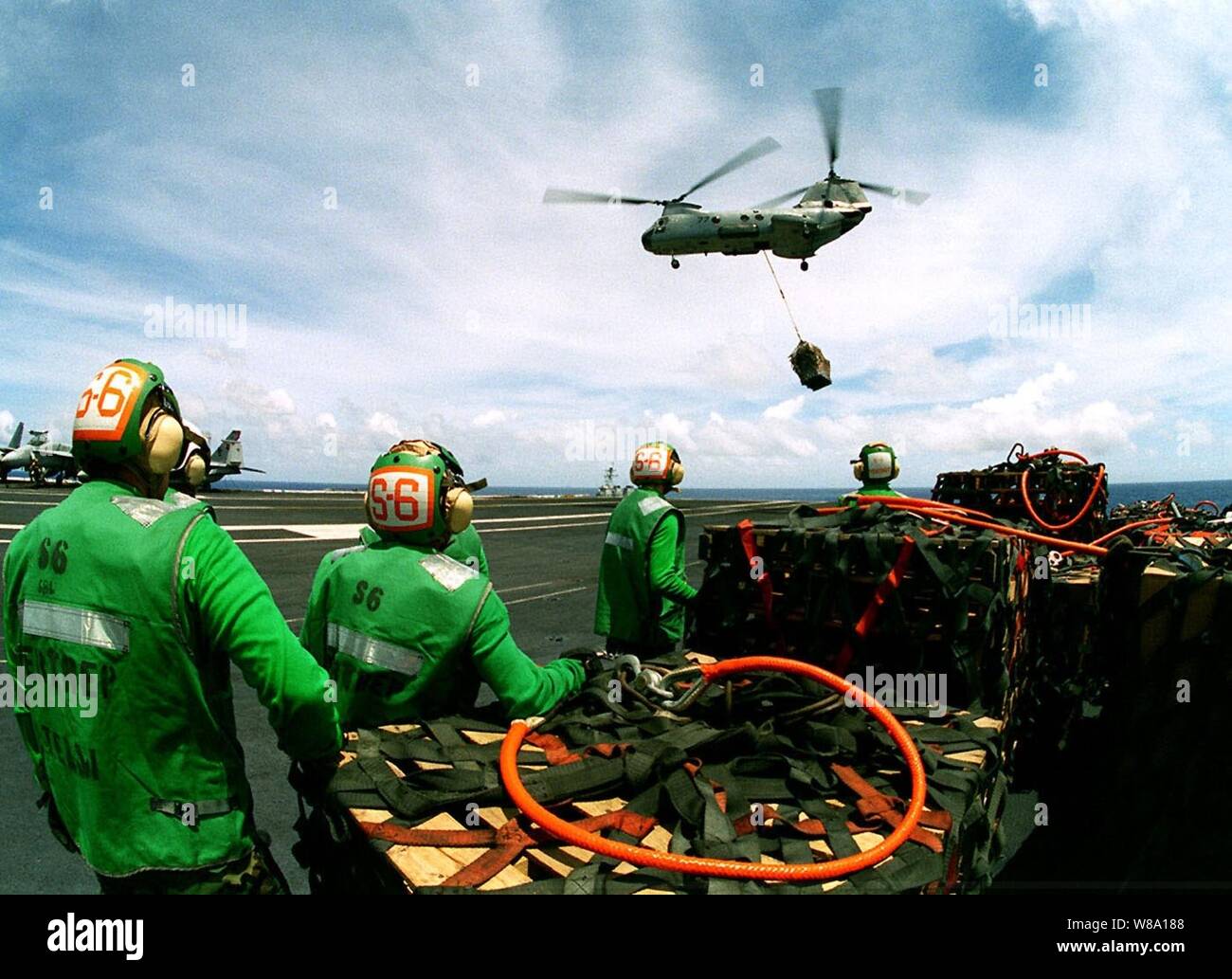 Members of the USS Constellation (CV-64) supply department watch as a ...