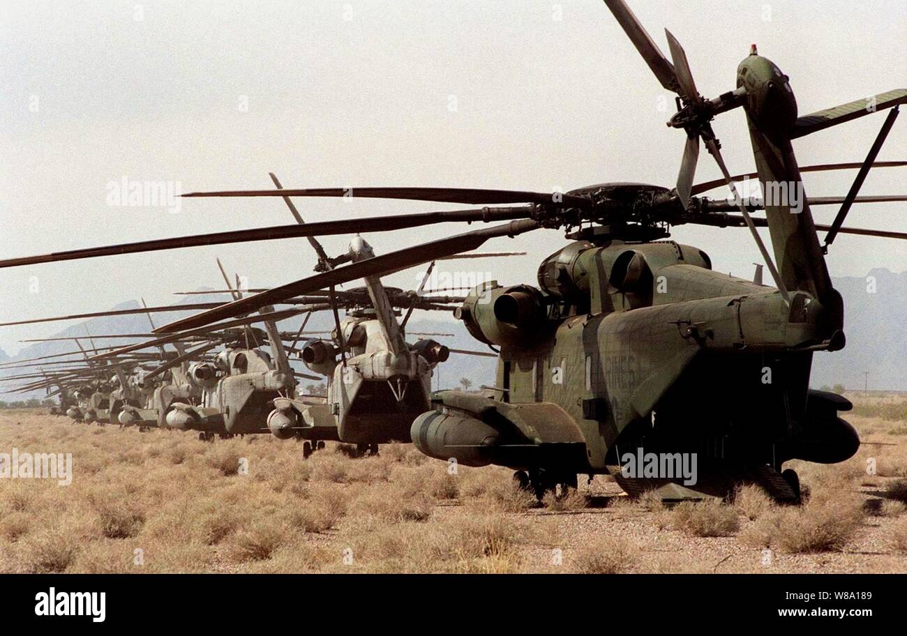 U.S. Marine Corps CH-53 Sea Stallion helicopters are parked in a line ...