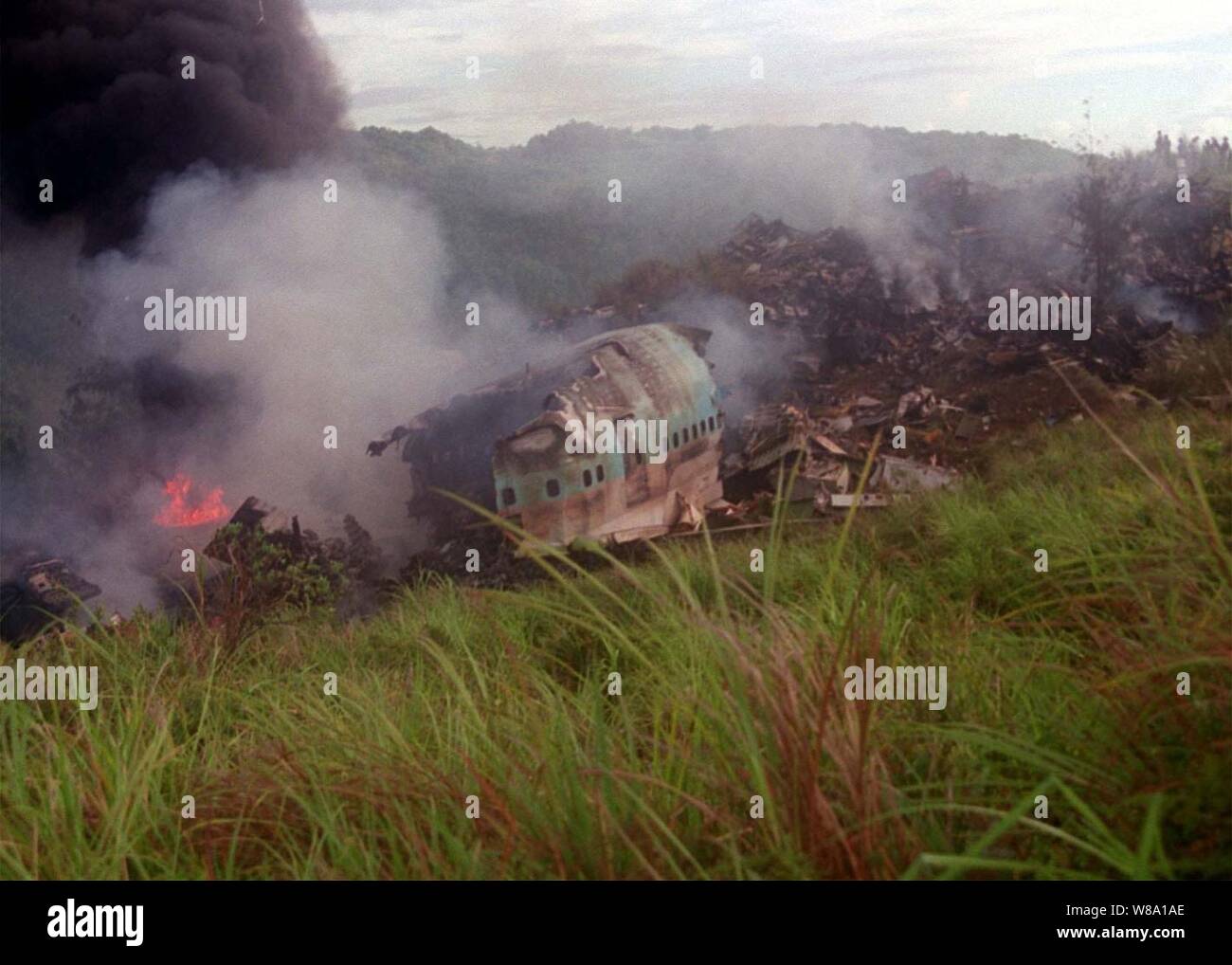Wreckage of the Korean Airlines flight 801 burns at the Sasa Valley ...