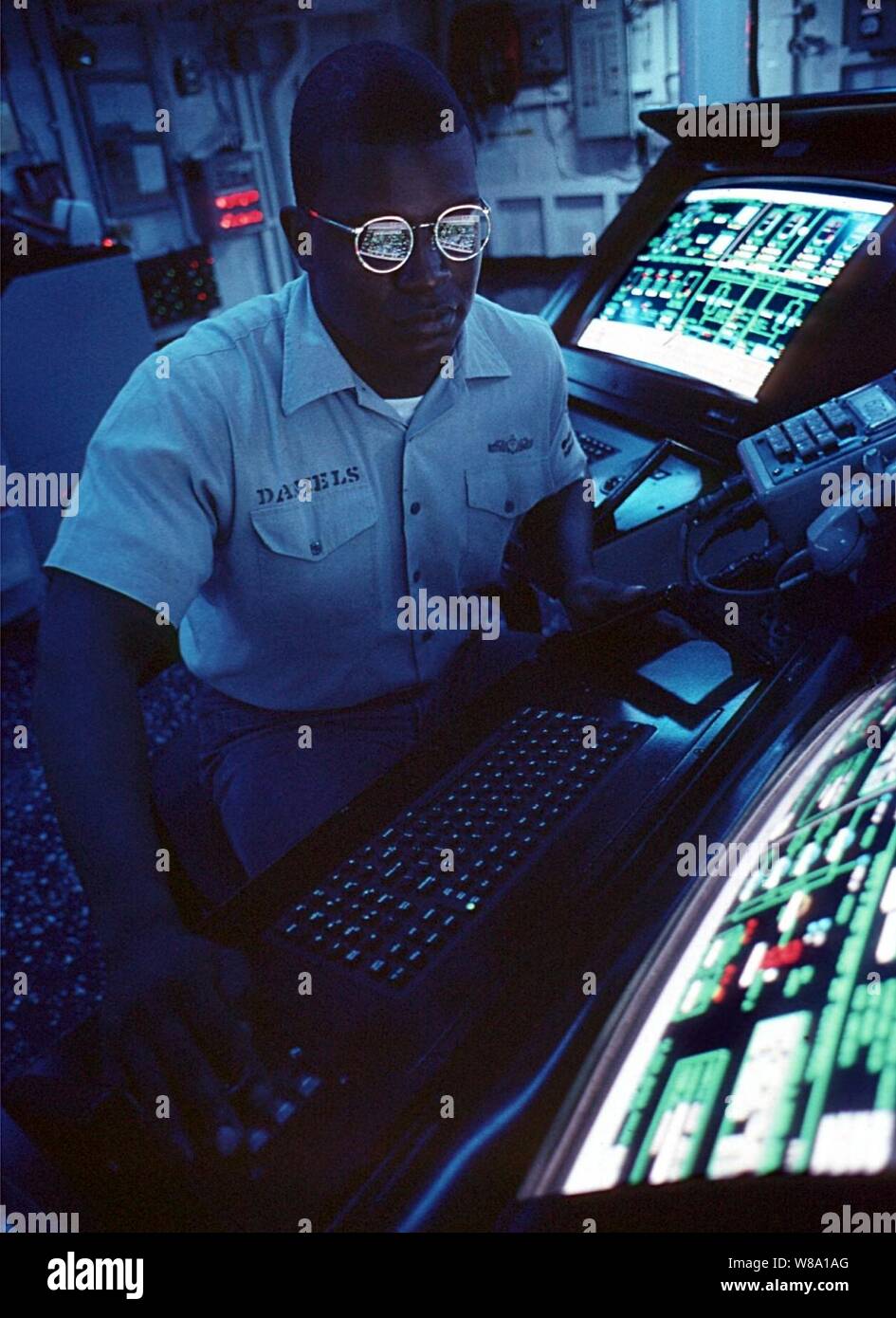 Petty Officer 2nd Class Cleveland C. Daniels checks a pumpХs status on ...