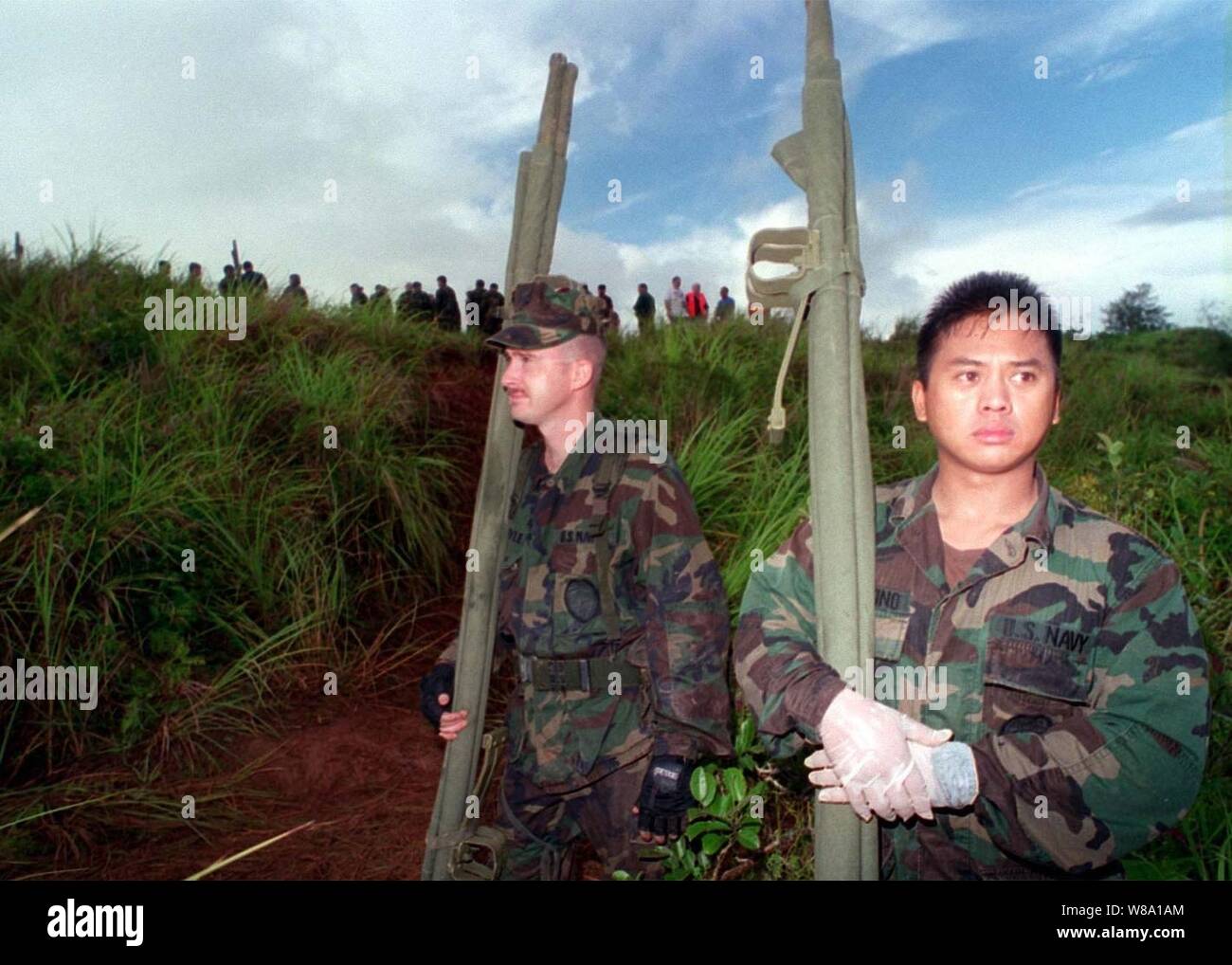 U. S. Navy Auxiliary Security Force members stand by to assist in ...