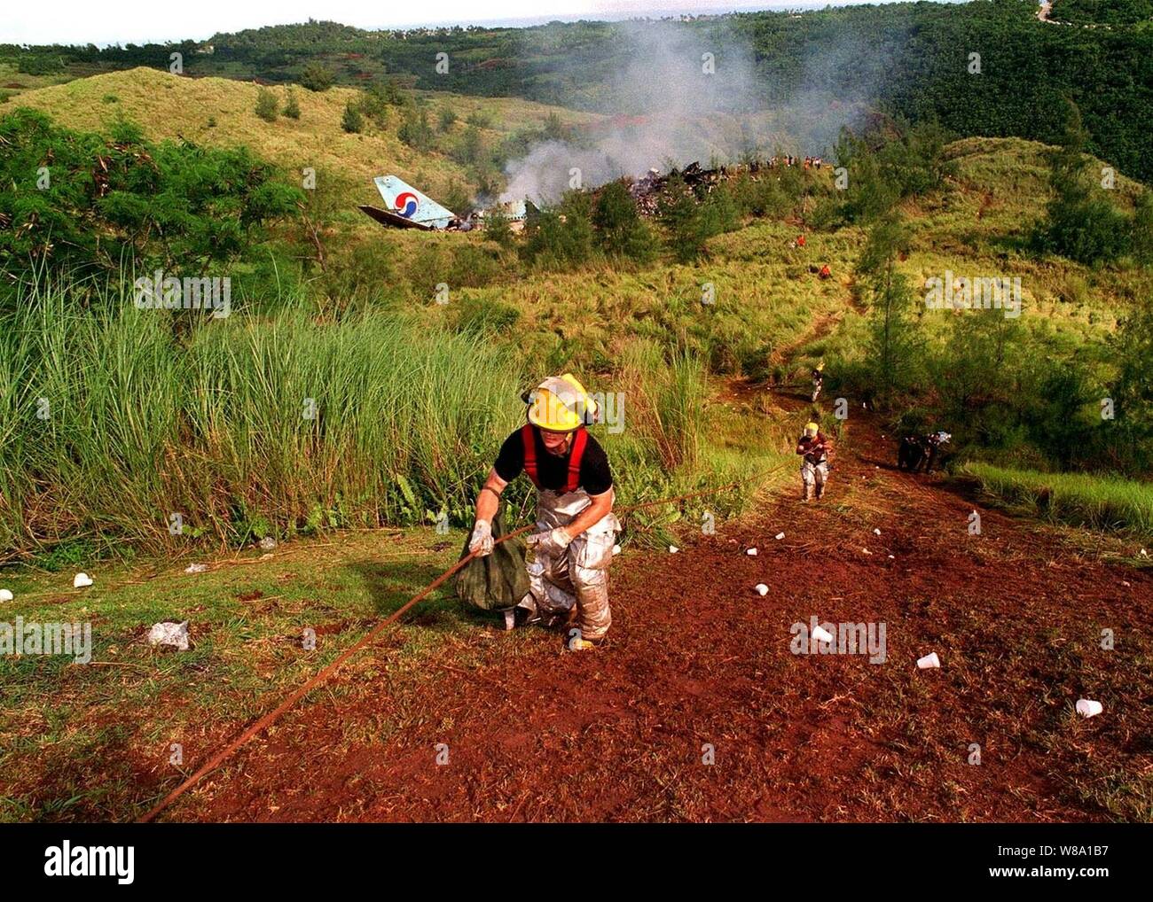 Fire fighters use an ascent line to pull themselves up the steep slope ...
