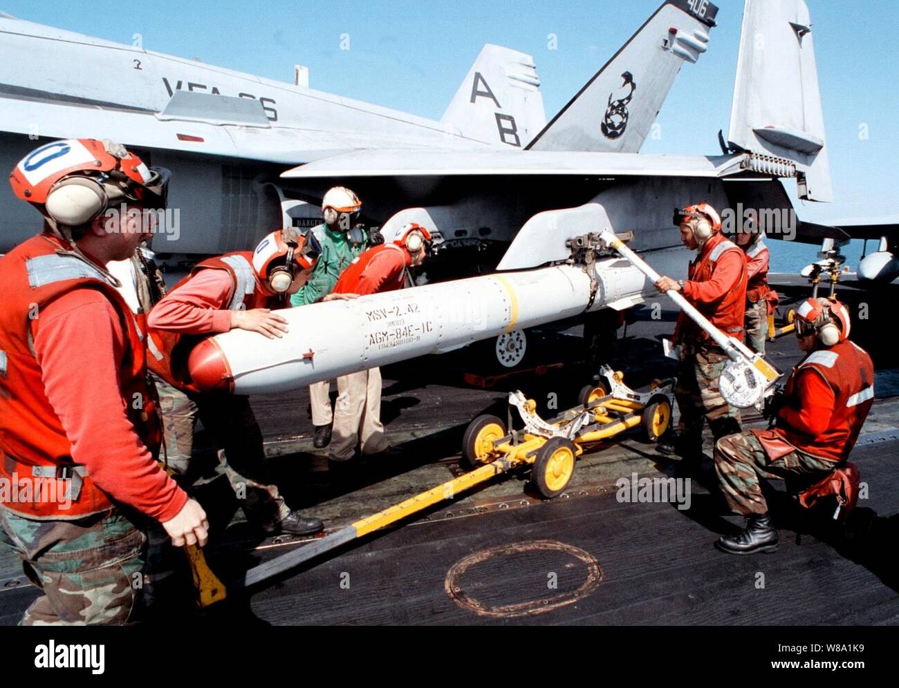 Aviation ordnancemen load an AGM-84E Standoff Land-Attack Missile onto ...