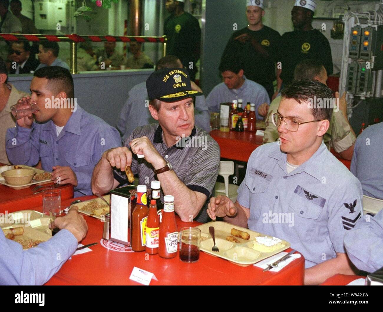 Secretary of Defense William S. Cohen (center) joins crew members of ...