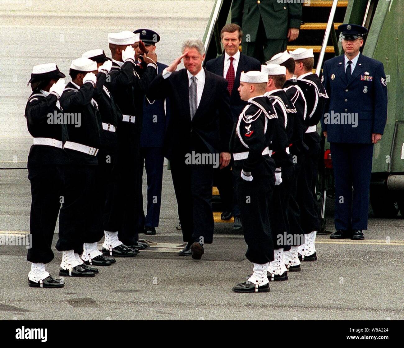 President Bill Clinton goes through the traditional Navy sideboys ...