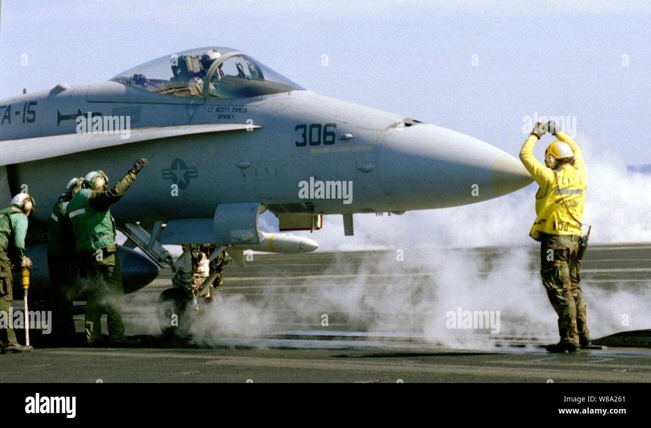 A U.S. Navy F/A 18C Hornet is prepared for a catapult launch from the ...
