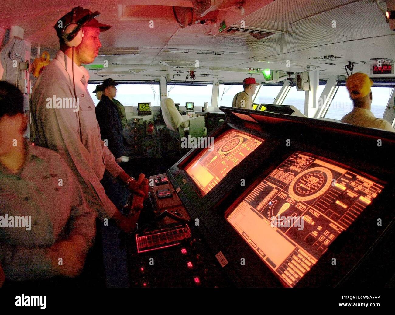 Seaman Shaun J. Toole mans the computerized helm of the USS Harry S ...