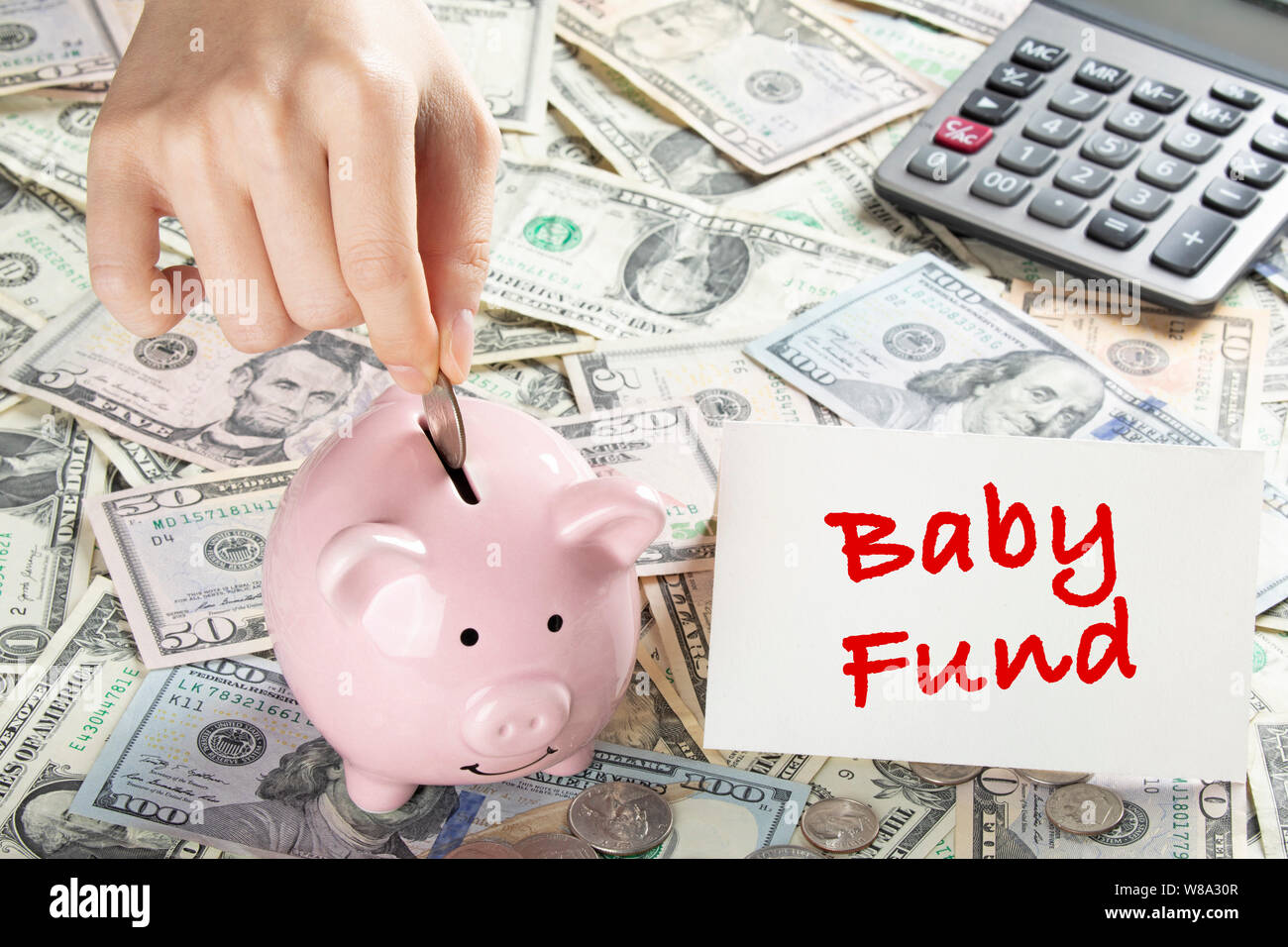 United States bank notes and coins with a calcultor, piggy bank, and ...