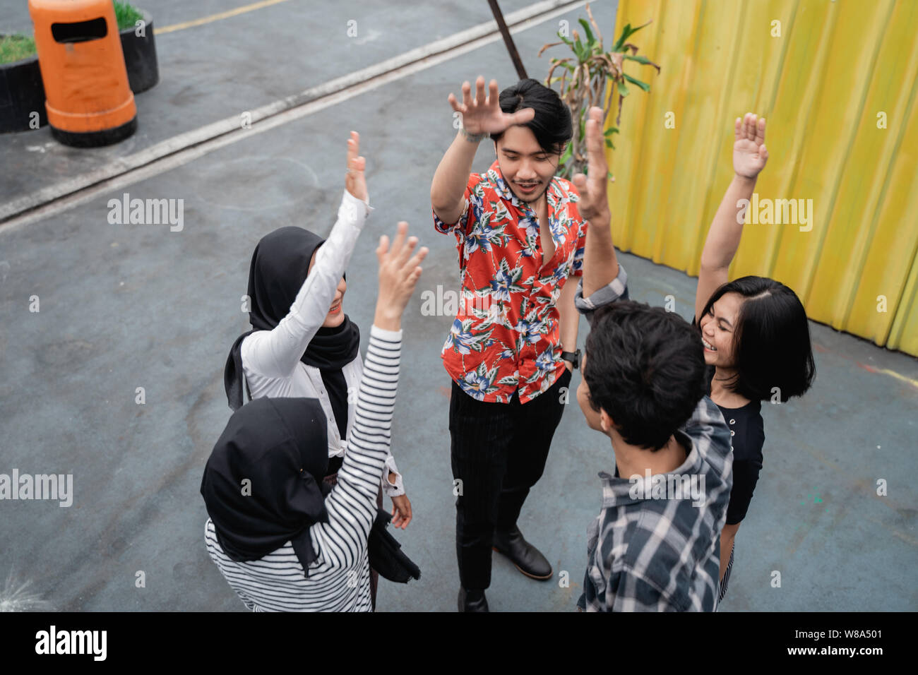 group of friends raised hands Stock Photo - Alamy