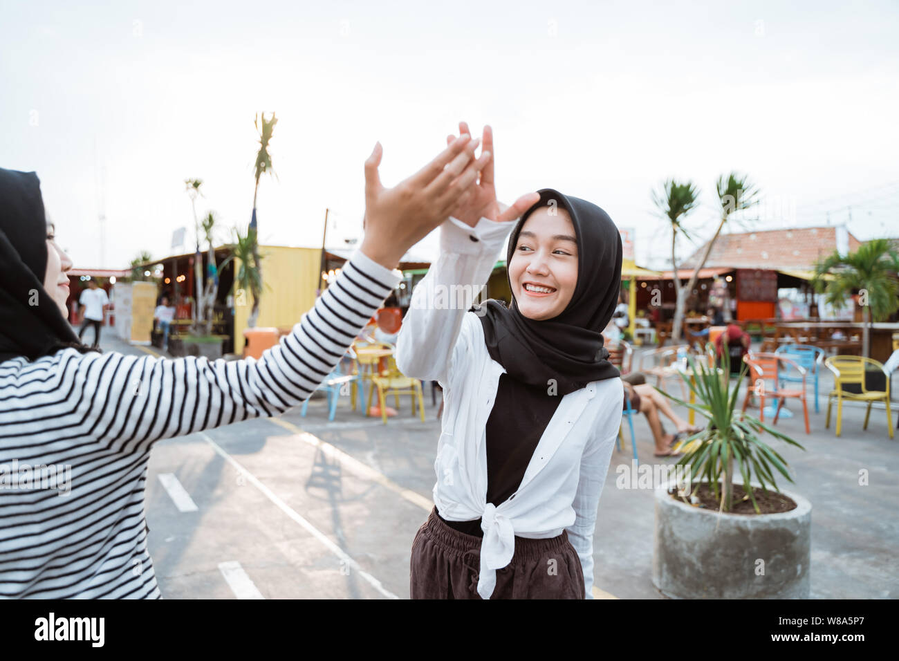young hijab woman high five with friends Stock Photo - Alamy