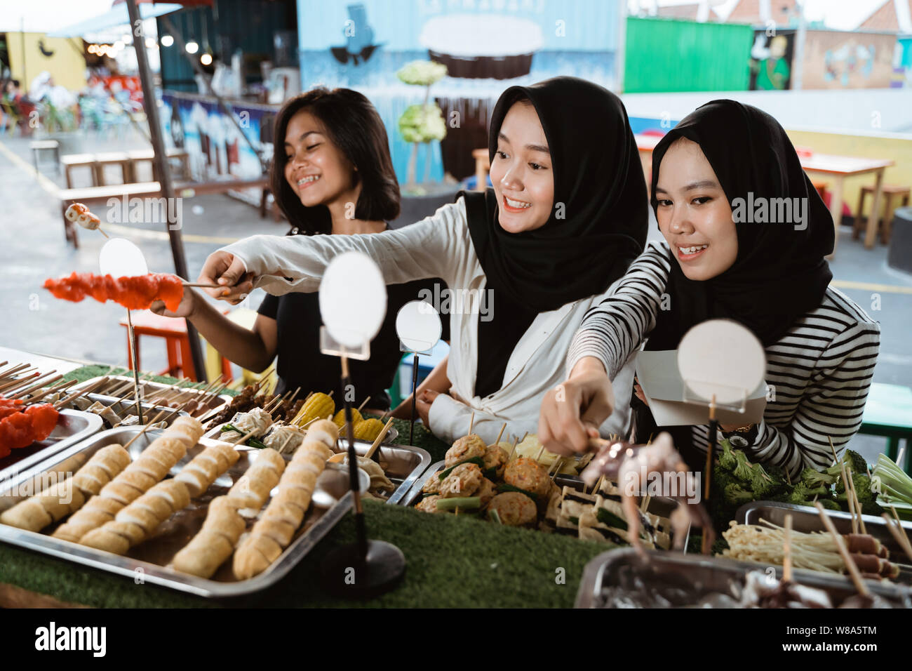 group of young women at a street food restaurant Stock Photo - Alamy