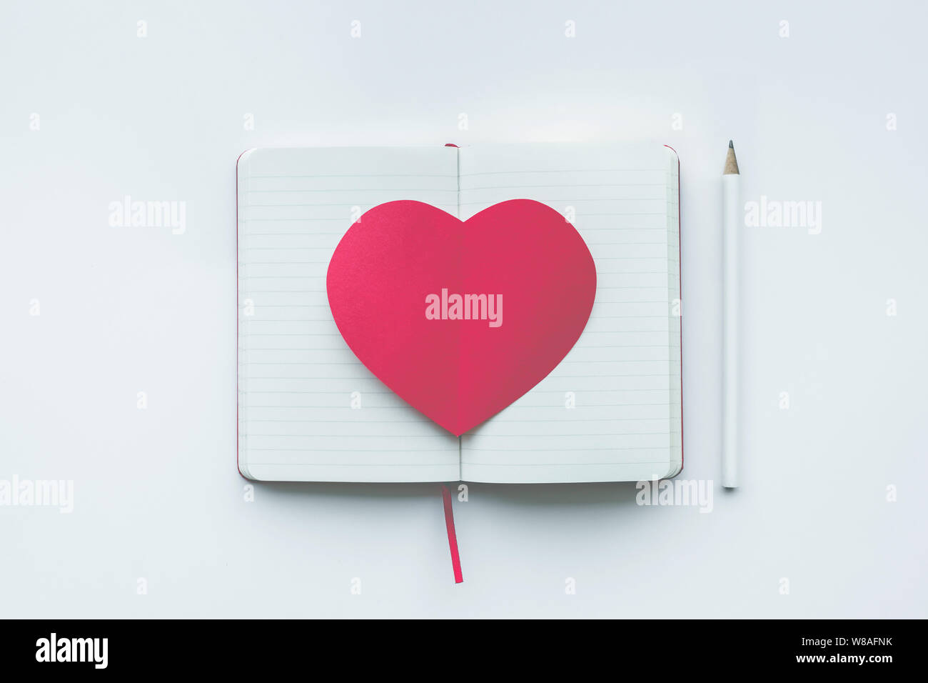 Red heart shape on white notepad background.love, valentine,wedding ...