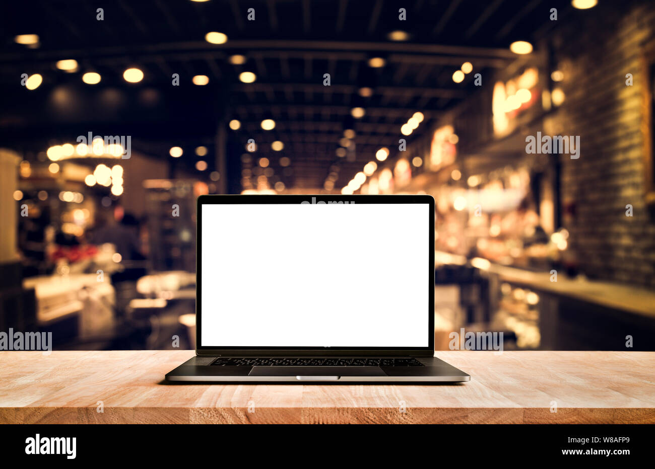 Modern computer,laptop with blank screen on table cafe shop backgrounds ...
