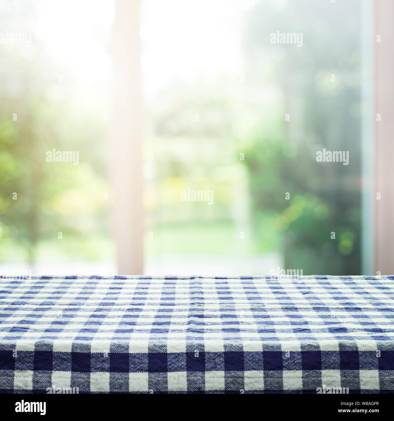 Checkered tablecloth texture top on blur of window and garden ...