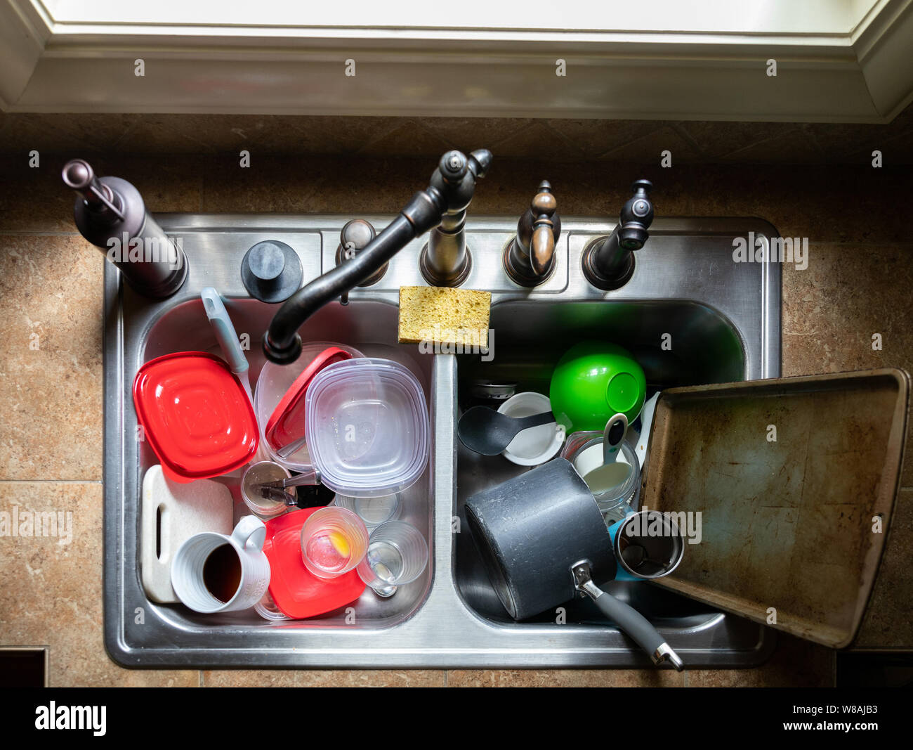 Stack of dirty dishes piled into the kitchen sink Stock Photo - Alamy