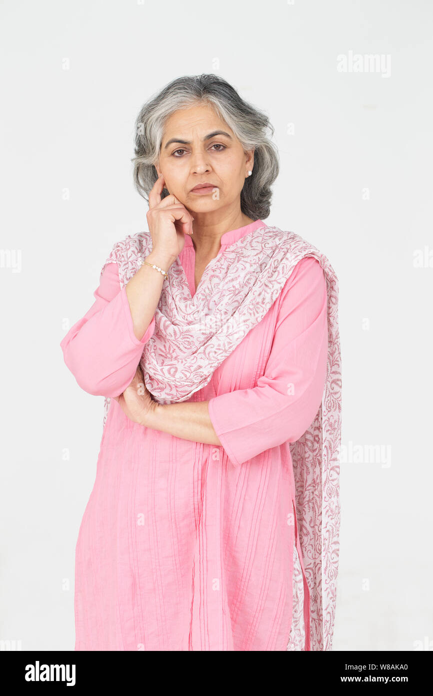 Senior woman thinking and looking sad Stock Photo - Alamy