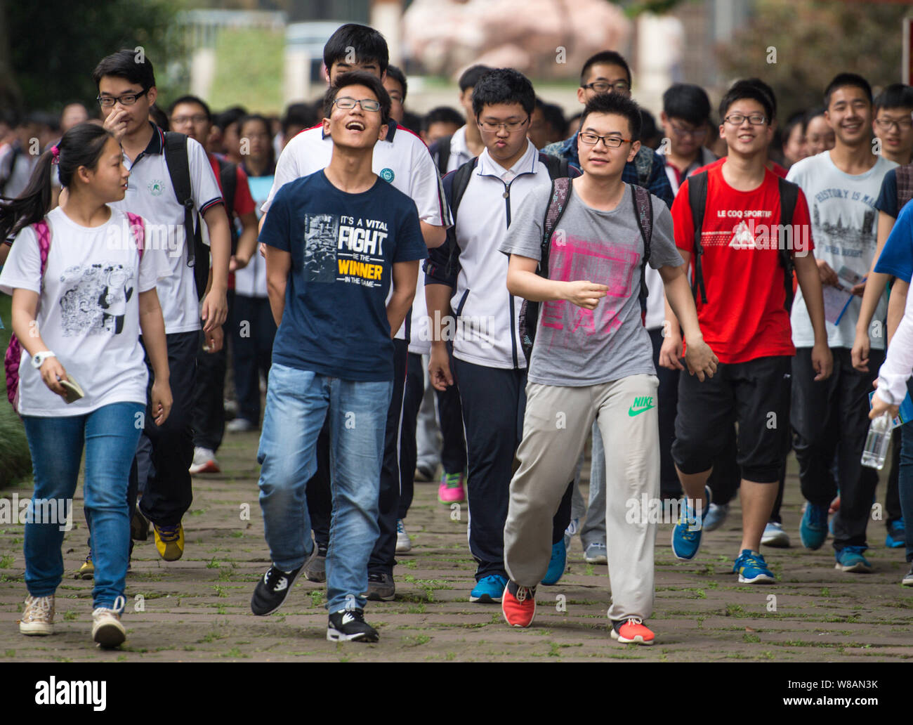 Chinese students exit from a school after finishing an examination of ...