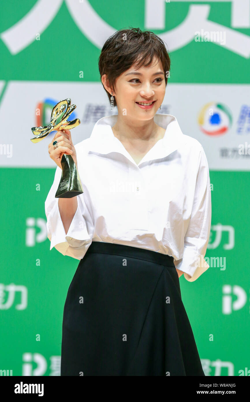 Chinese actress Sun Li poses with her trophy for the Best Actress award ...