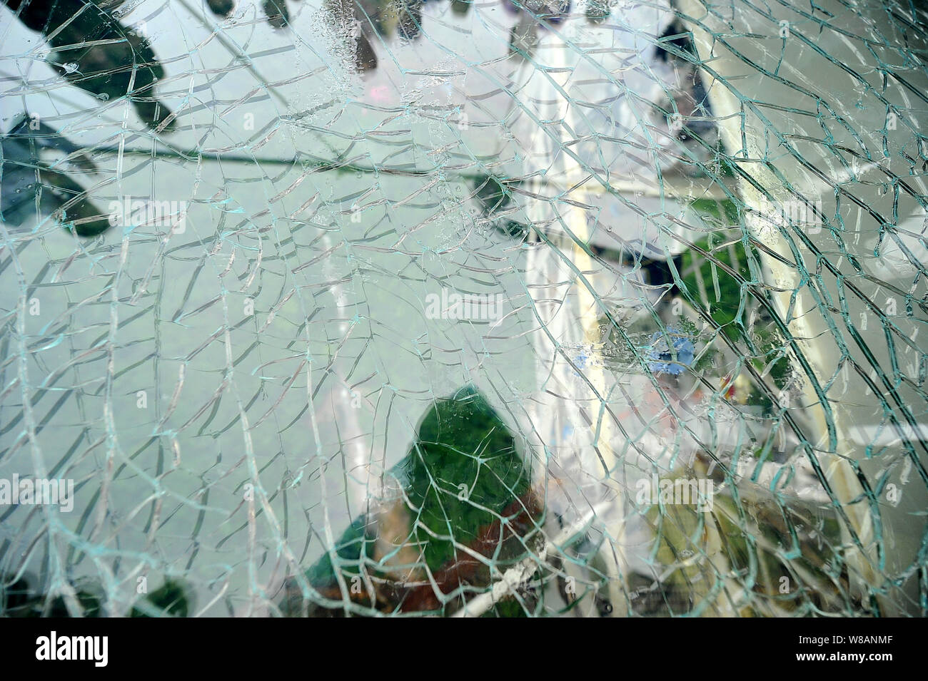 Chinese visitors look at the cracked glass smashed by them during a ...
