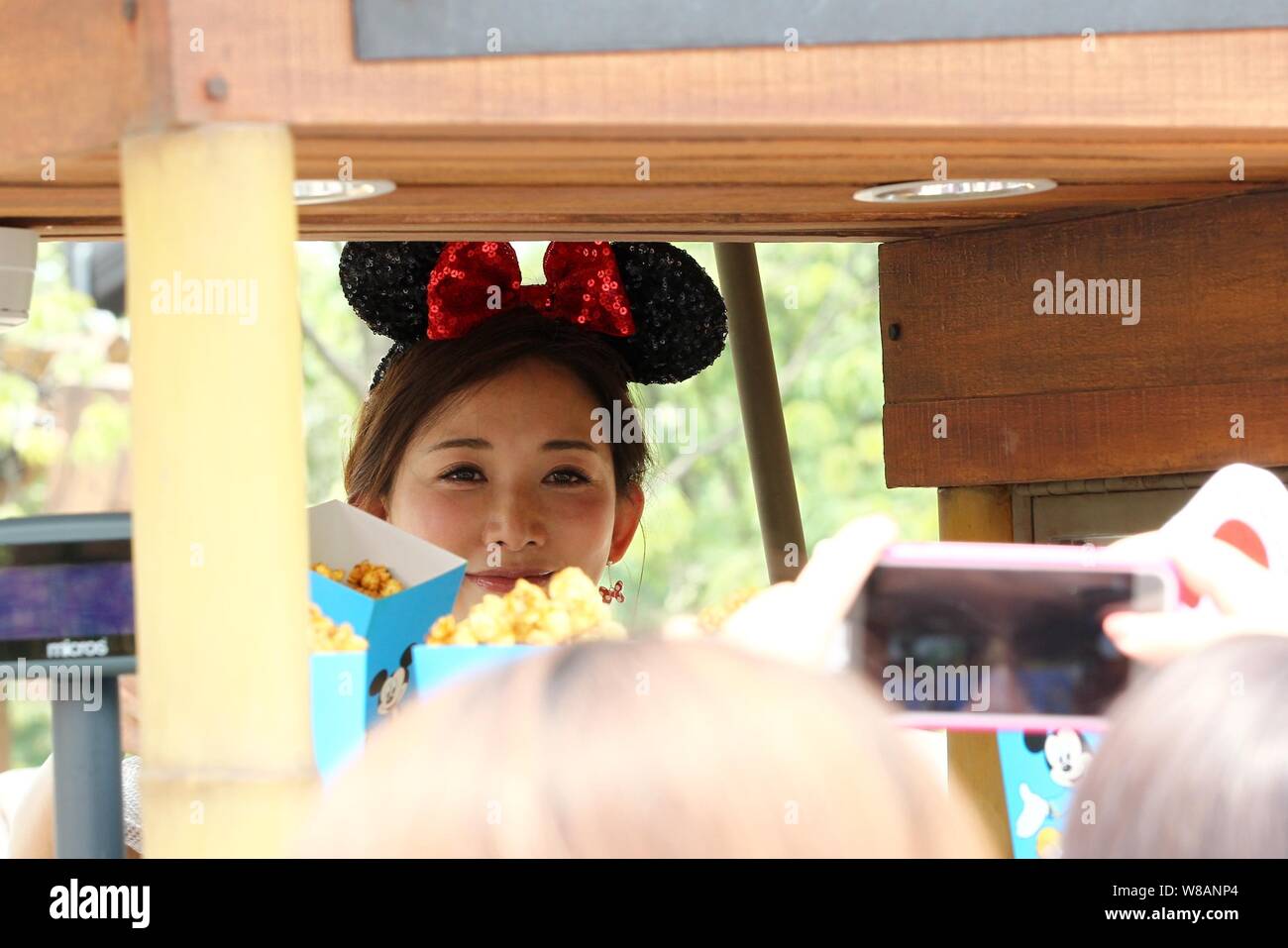 Taiwanese model and actress Lin Chi-ling wearing Minnie Mouse headwear ...