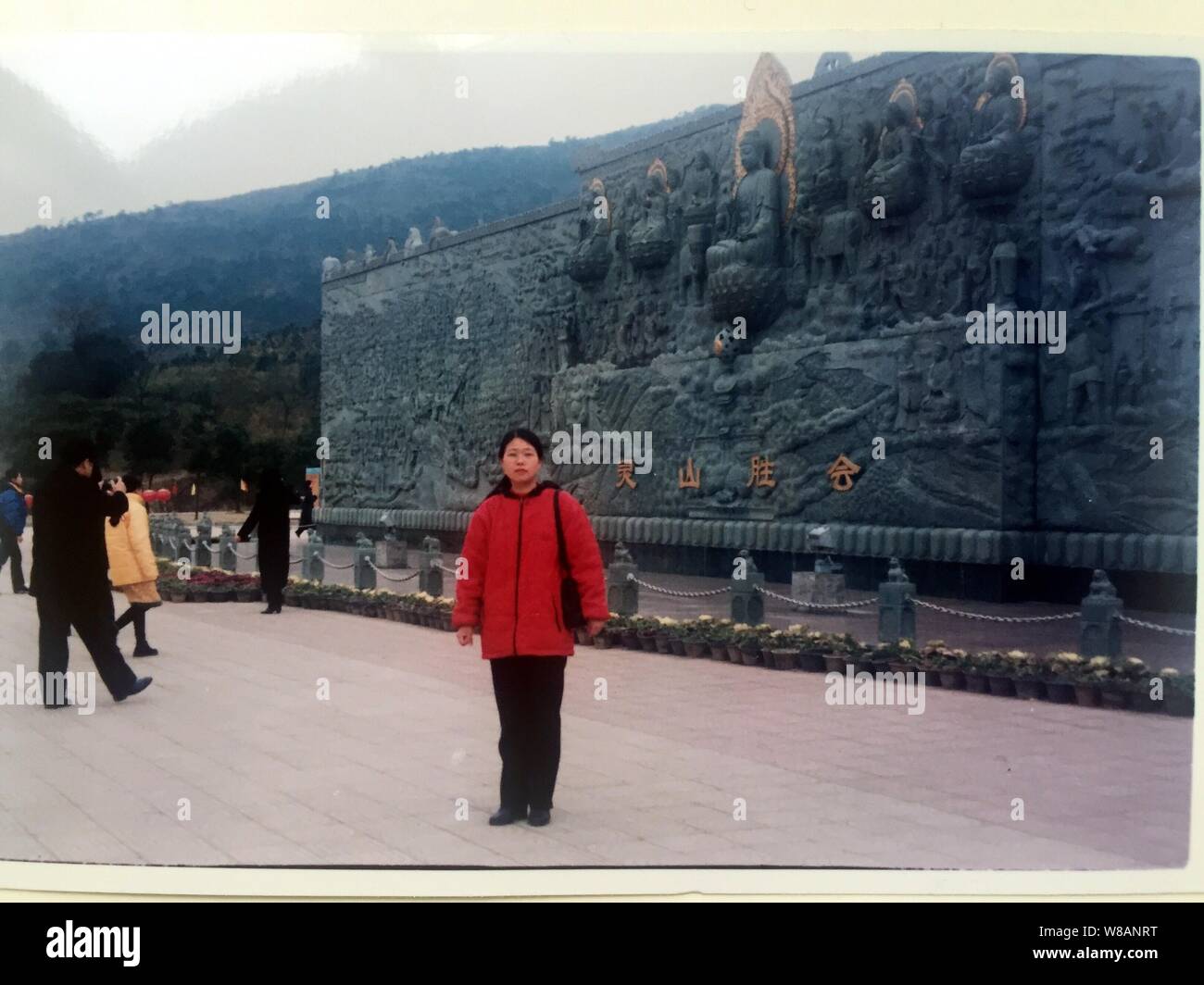 A file photo taken in 2000 shows the mother of Lu Yiqin, in red, during ...