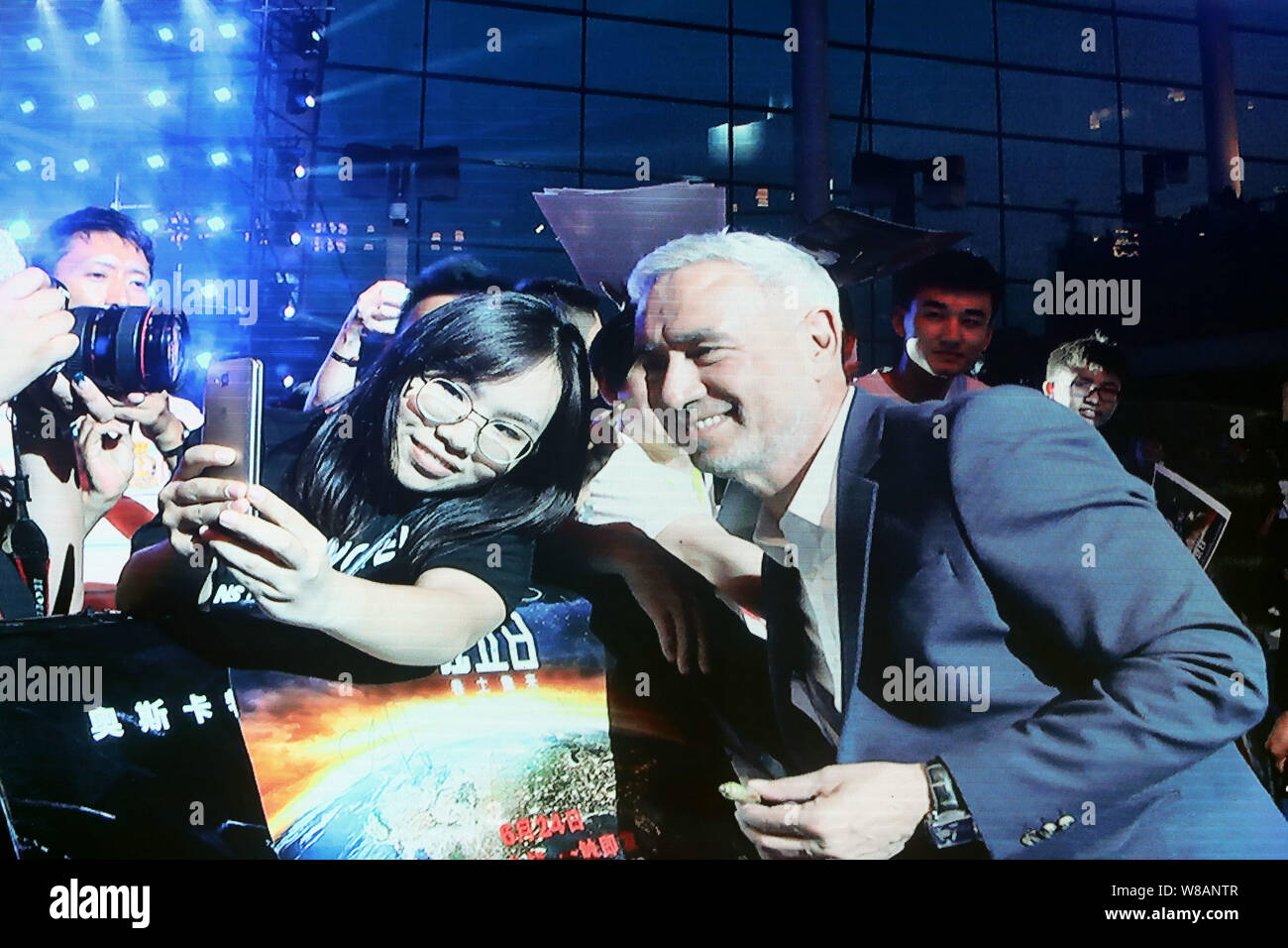 German film director Roland Emmerich, right, poses for selfies with ...