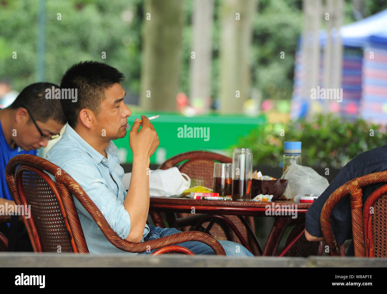 --FILE--A Chinese man smokes a cigarette at a teahouse in Hangzhou city ...