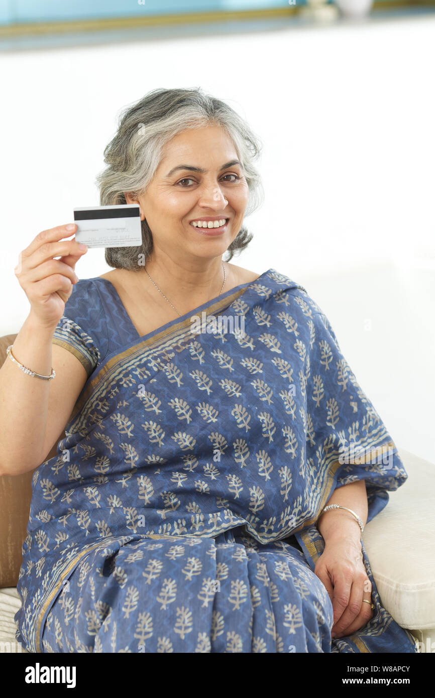 Senior woman showing a credit card and smiling Stock Photo - Alamy