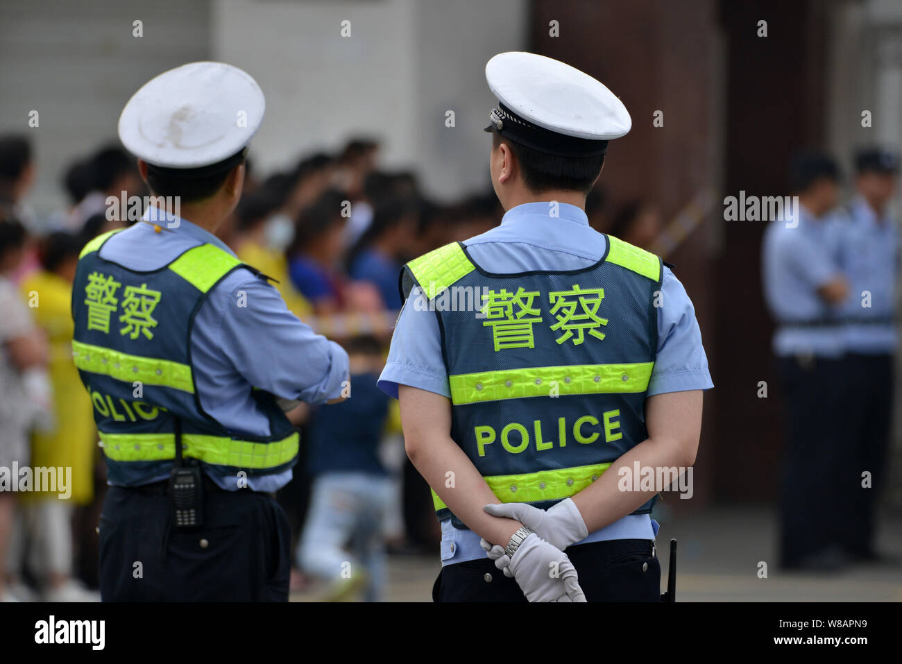 Chinese police officers stand guard outside a school during an ...