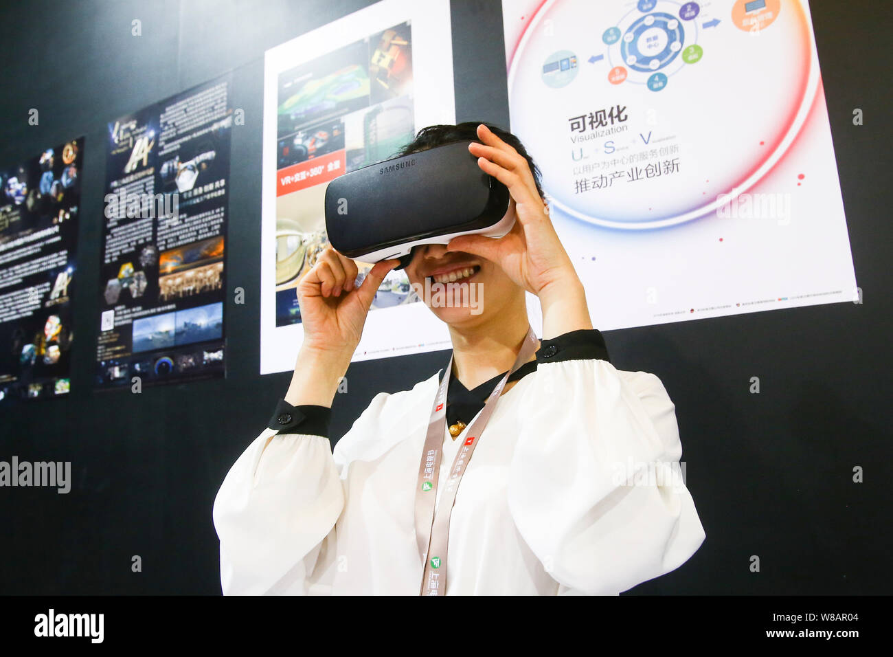 A visitor tries out a VR (Virtual Reality) device during an exhibition ...