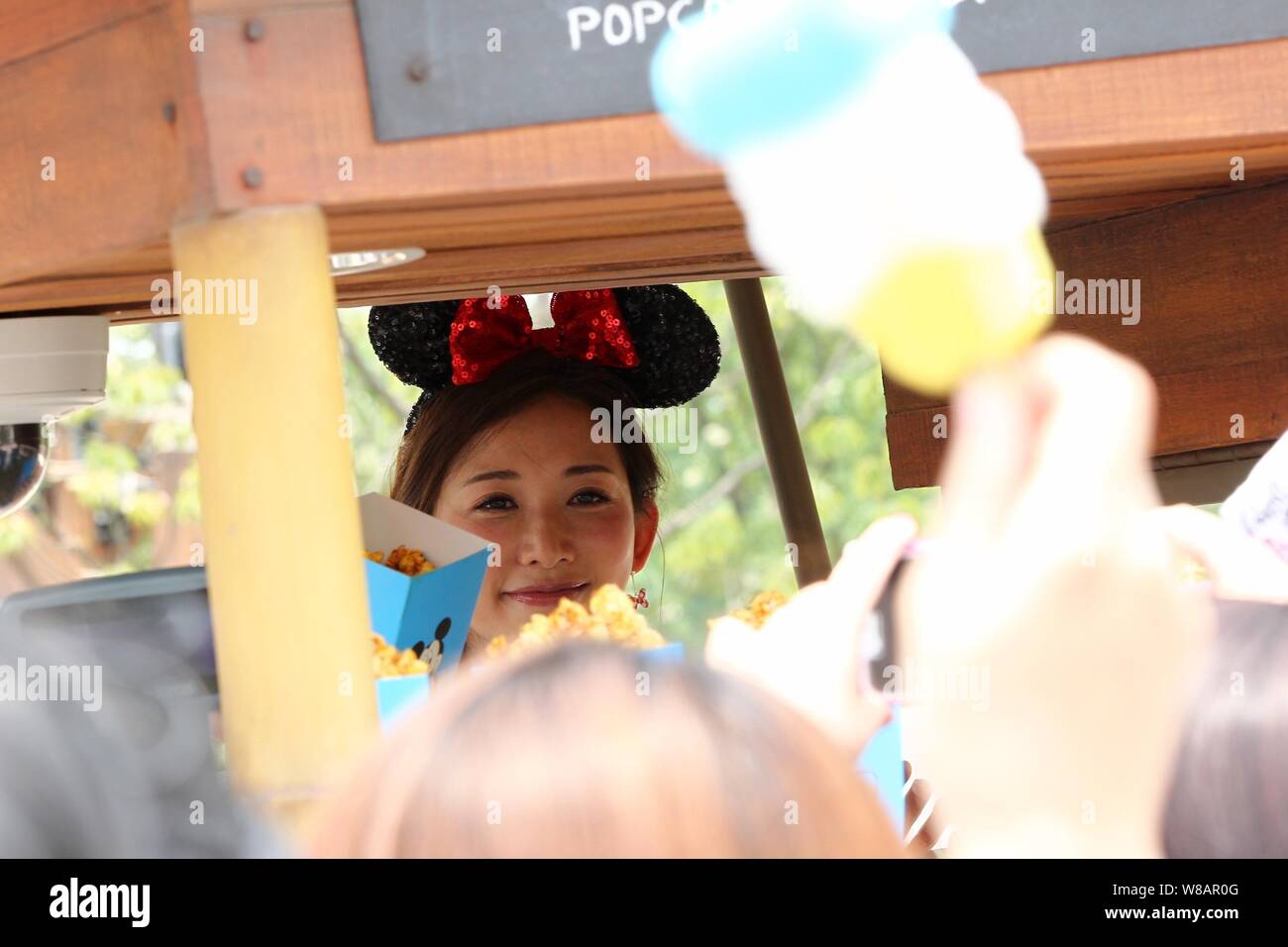 Taiwanese model and actress Lin Chi-ling wearing Minnie Mouse headwear ...