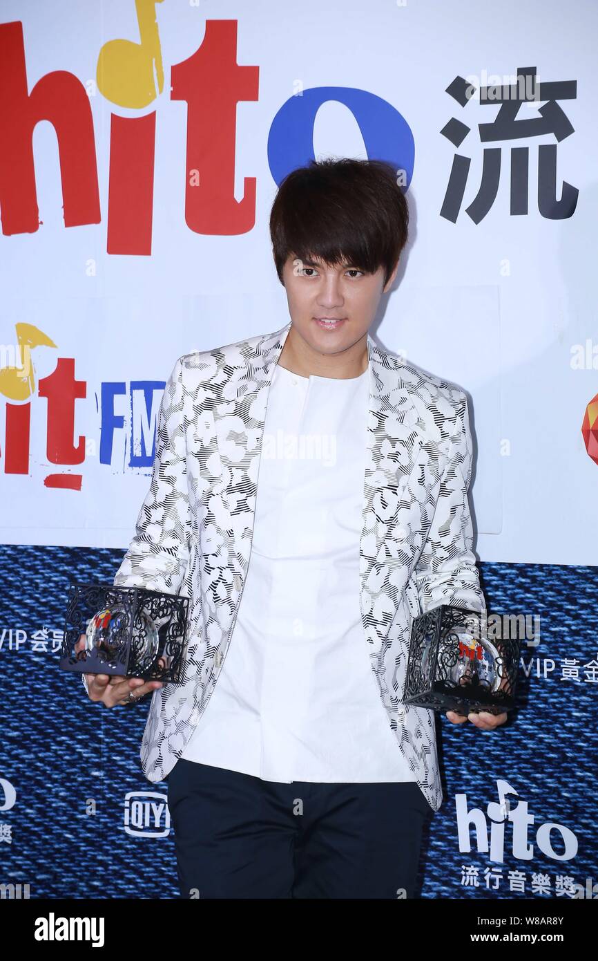 Taiwanese singer Kenji Wu poses with his trophies at the presentation ...