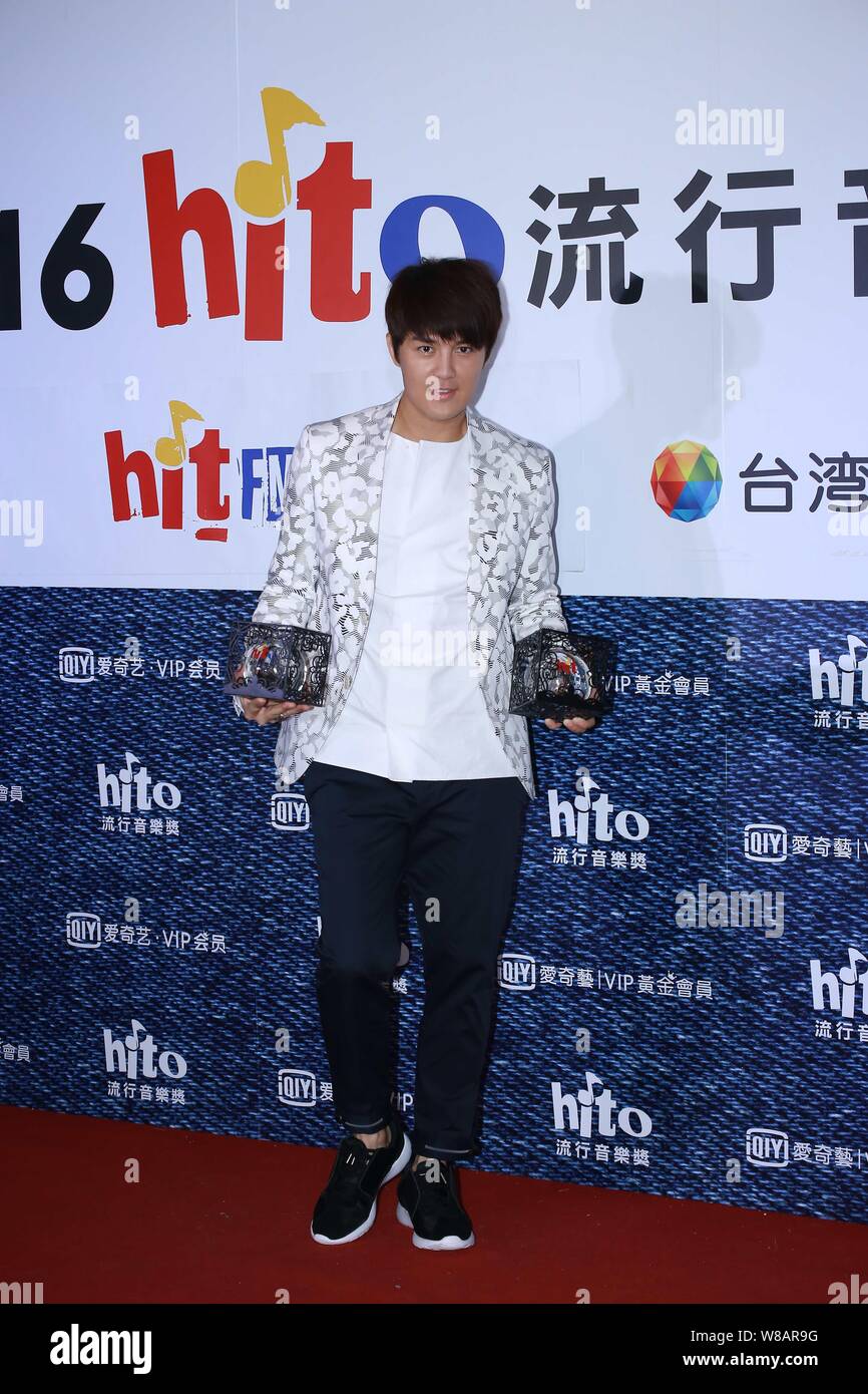 Taiwanese singer Kenji Wu poses with his trophies at the presentation ...