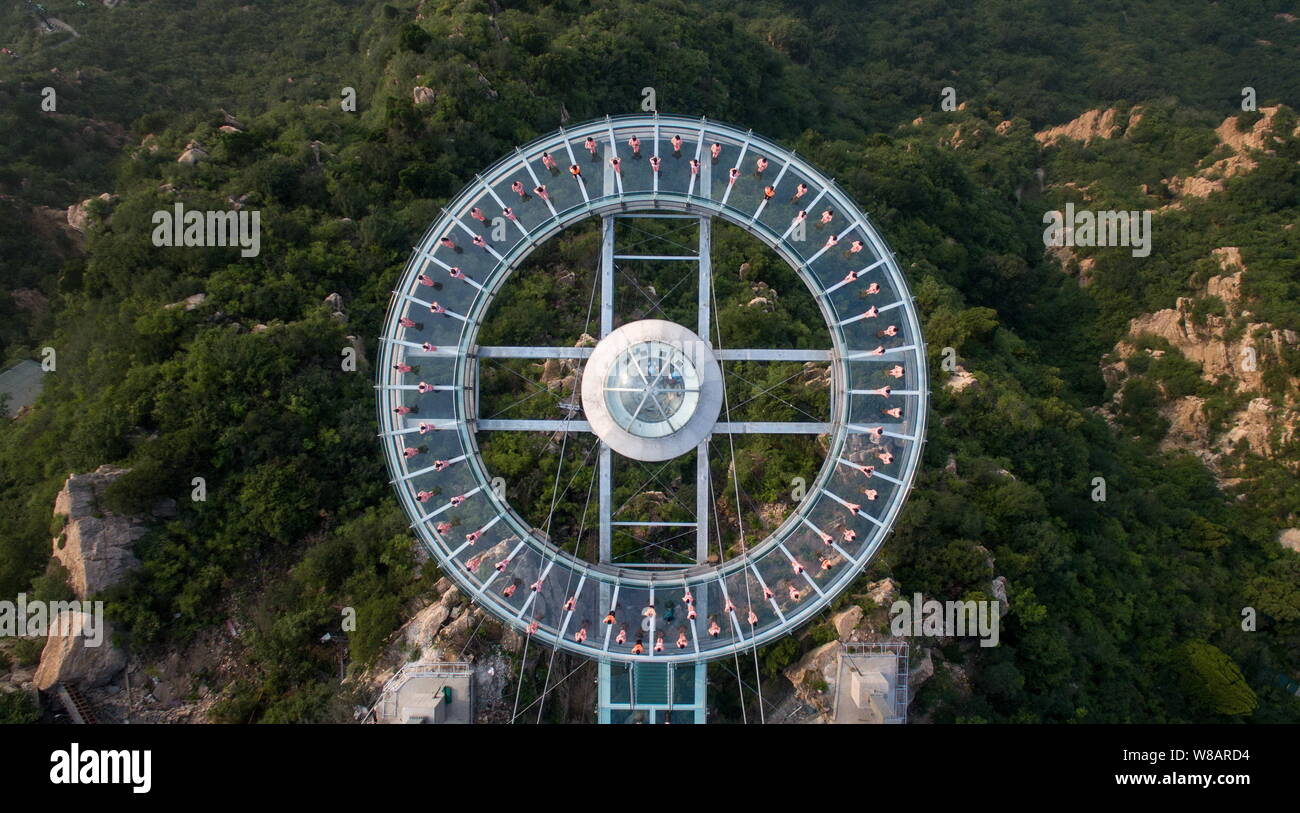 Aerial view of Chinese enthusiasts performing yoga on the glass ...