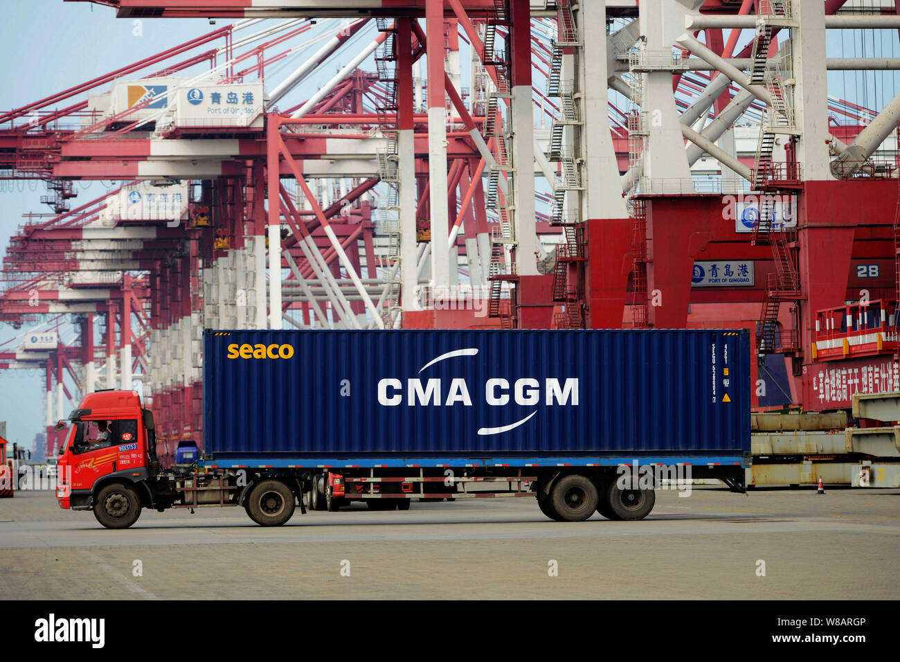A truck transports a container of CMA CGM on a quay at the Port of ...