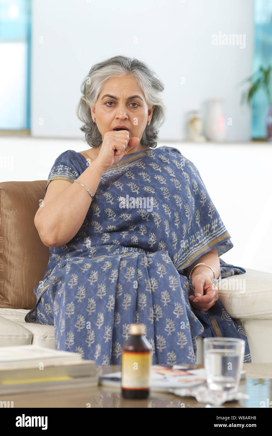 Senior woman coughing Stock Photo - Alamy