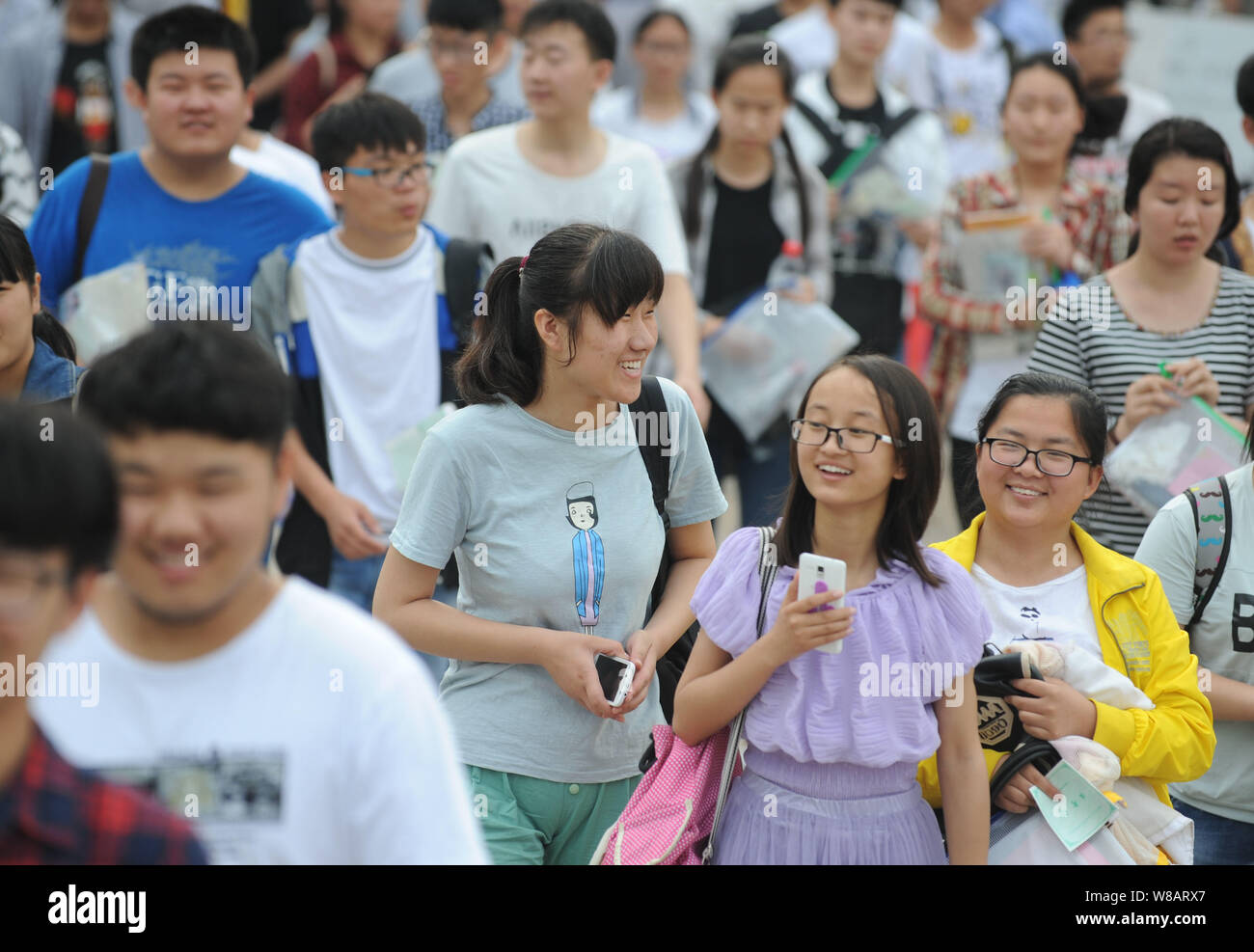 Chinese students arrive at a school to partake in an examination of the ...