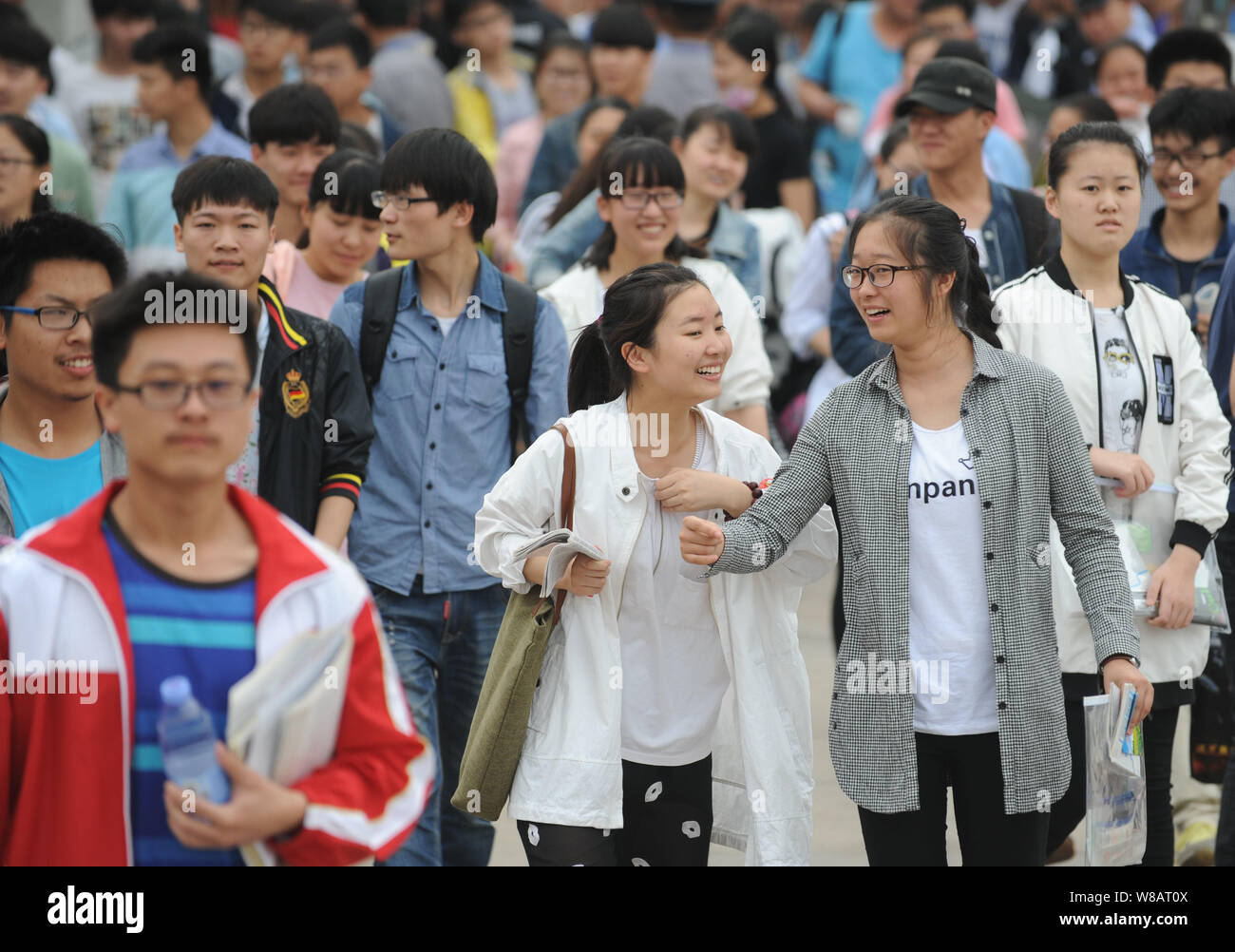 Chinese students arrive at a school to partake in an examination of the ...