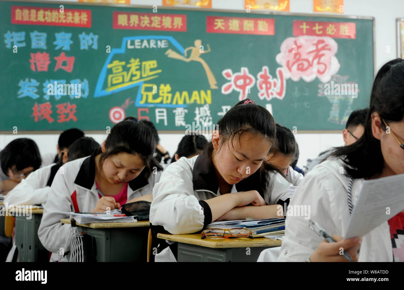 Chinese students review textbooks or write test papers to prepare for ...