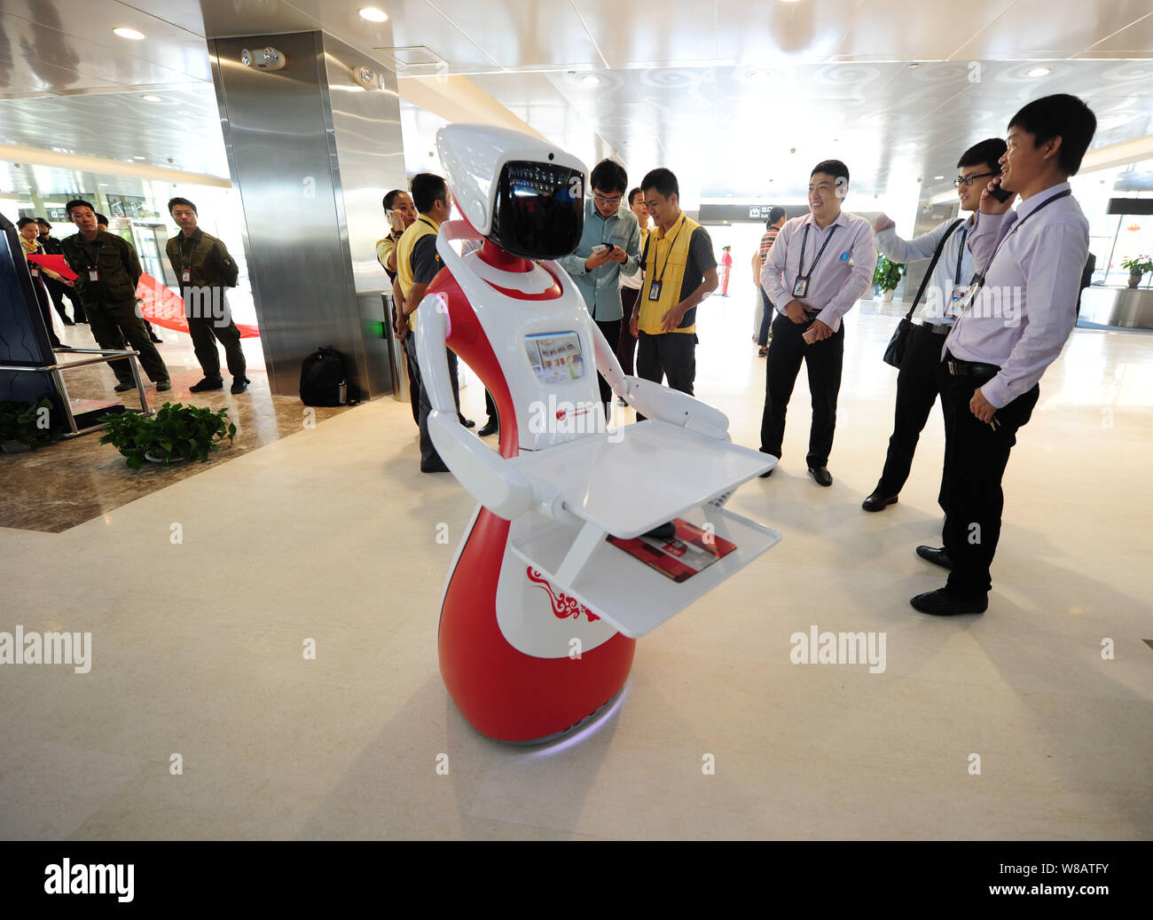 --FILE--A smart robot serves passengers at the Sanya Phoenix ...