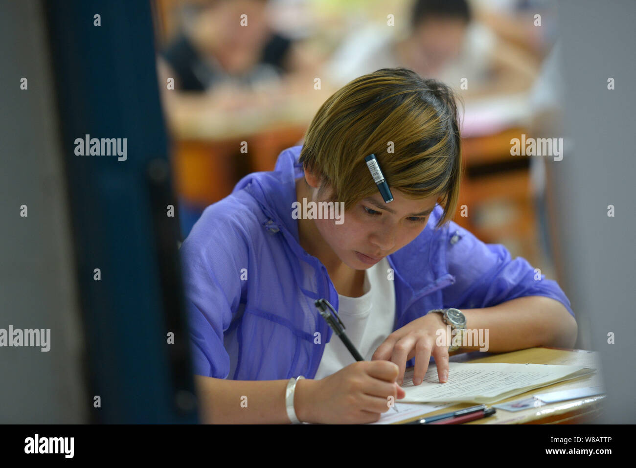 A Chinese student partakes in an examination of the national college ...