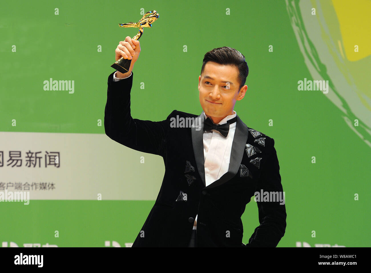 Chinese actor Hu Ge poses with his trophy for the Best Actor award for ...