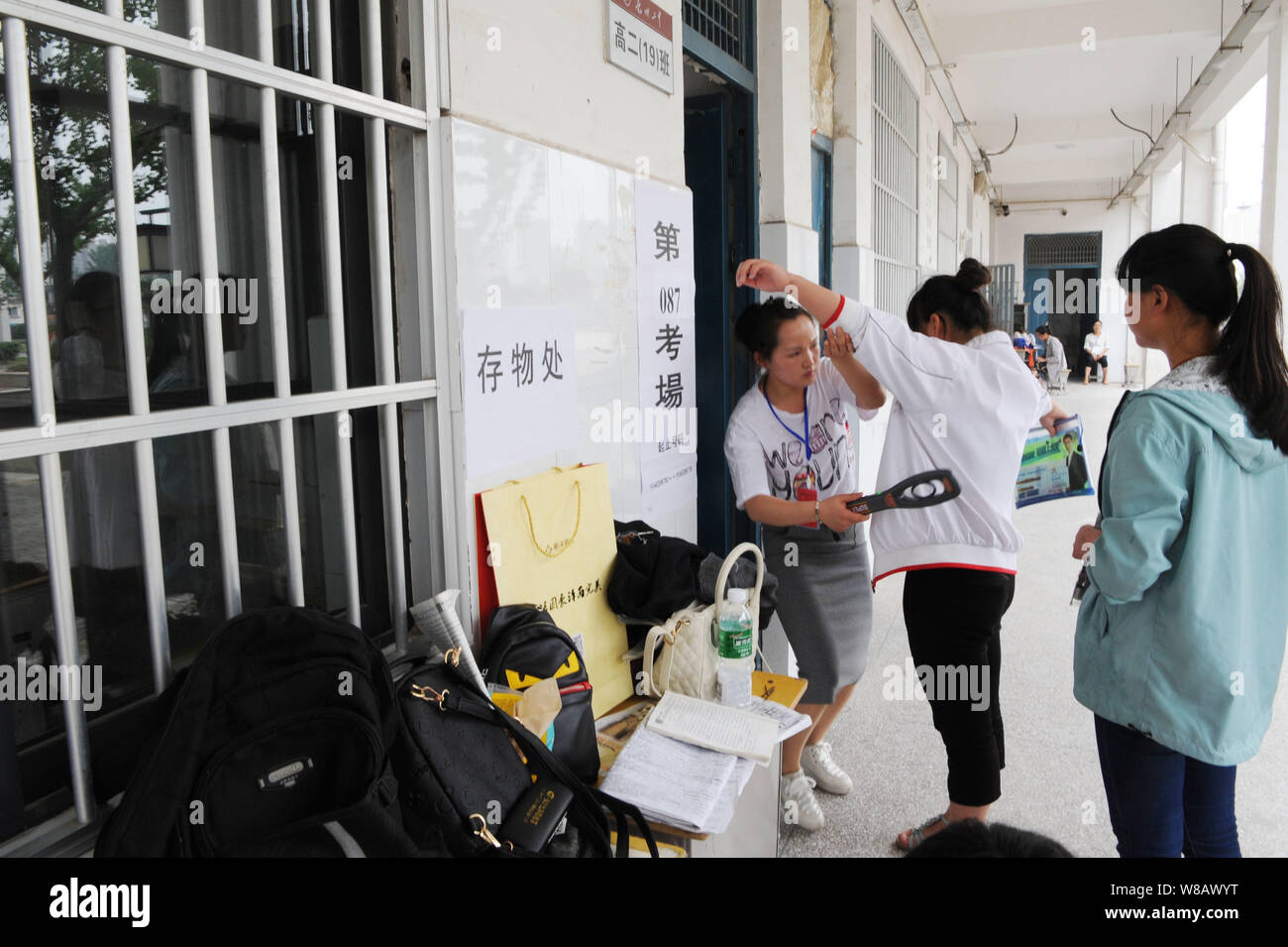 Chinese students queue up to receive security checks before entering ...