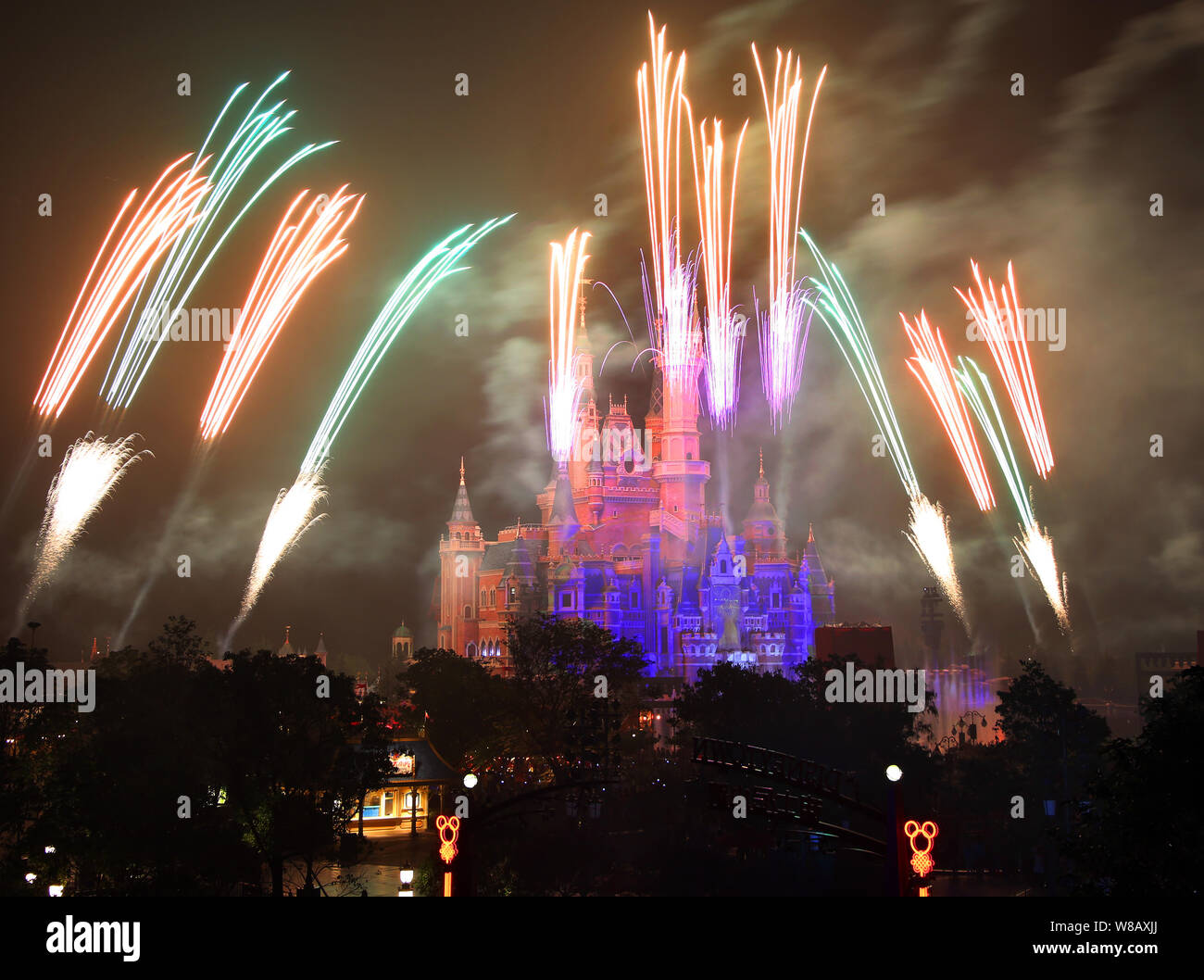 Fireworks explode over the Shanghai Disneyland at the Shanghai Disney ...